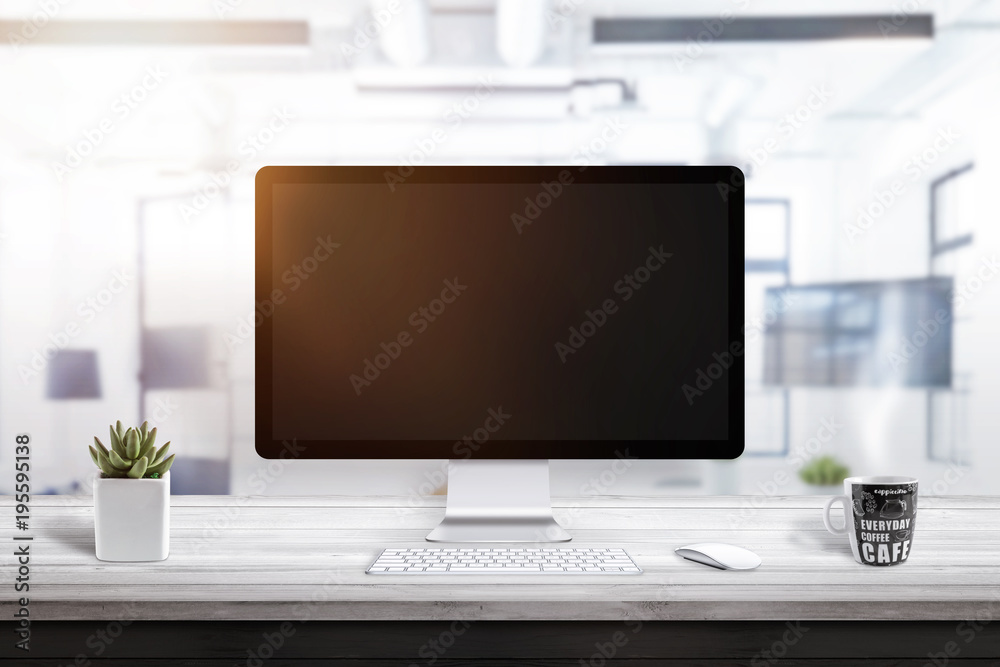 Empty computer display on office desk for mockup. Plant and coffee mug ...