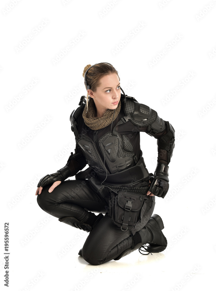 full length portrait of female soldier wearing black tactical armour ...