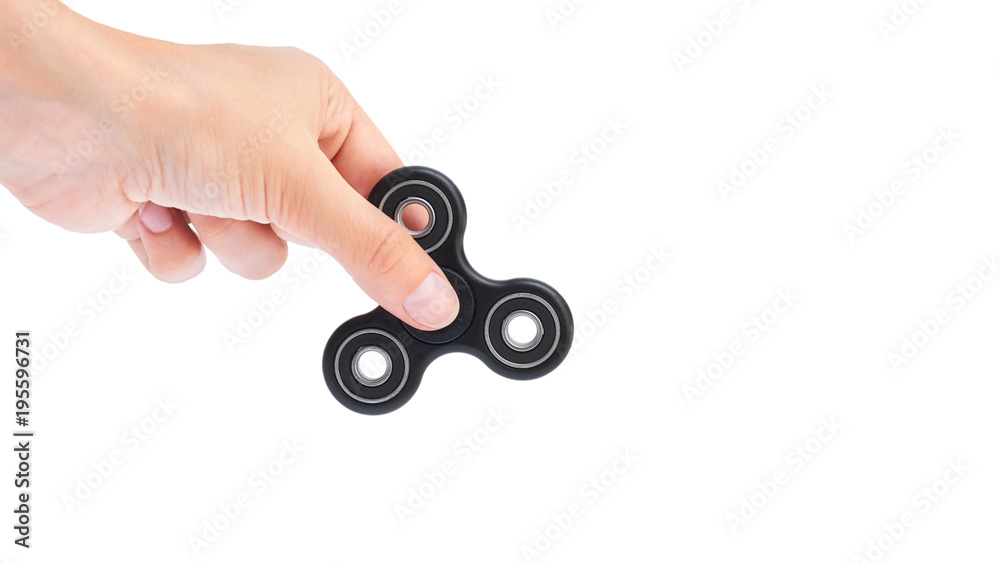 Hand holding Black Fidget Spinner isolated on white background. copy ...