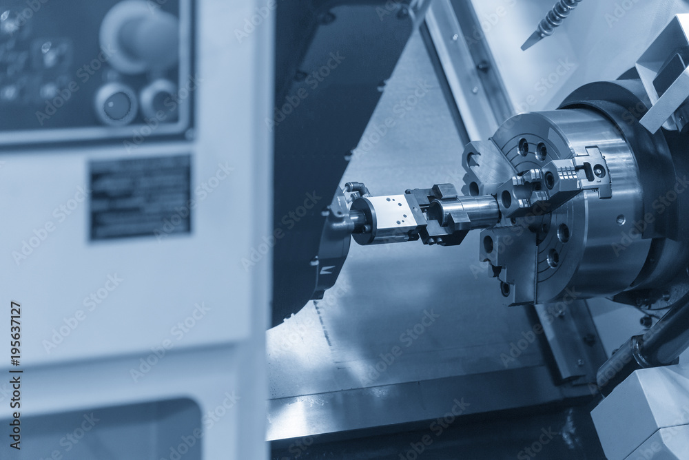 The CNC lathe machine setting the work pieces by robot arm.Industrial 4 ...