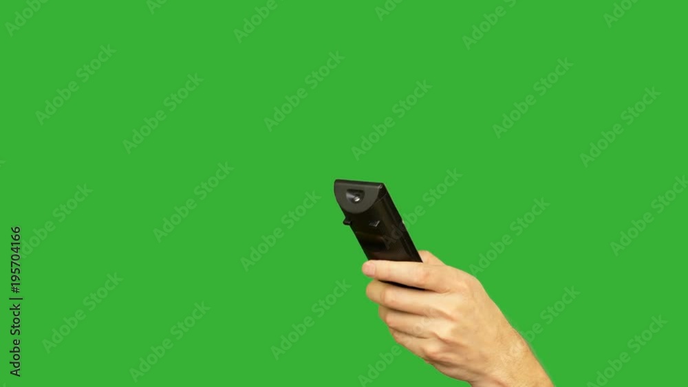 Hand with tv remote control isolated on green screen background. Low ...