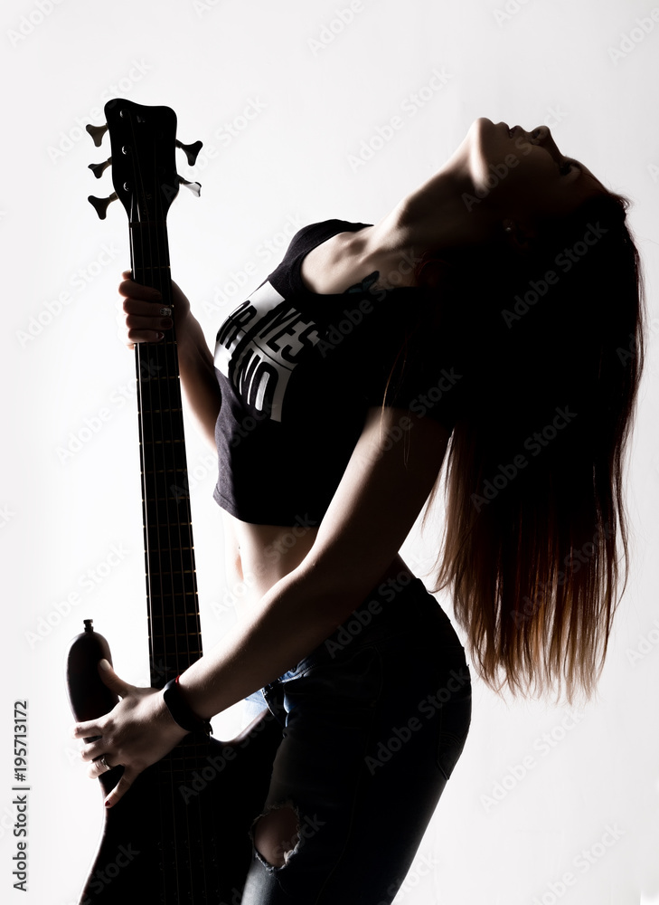 silhouette of rock woman playing on electric guitar on a white ...