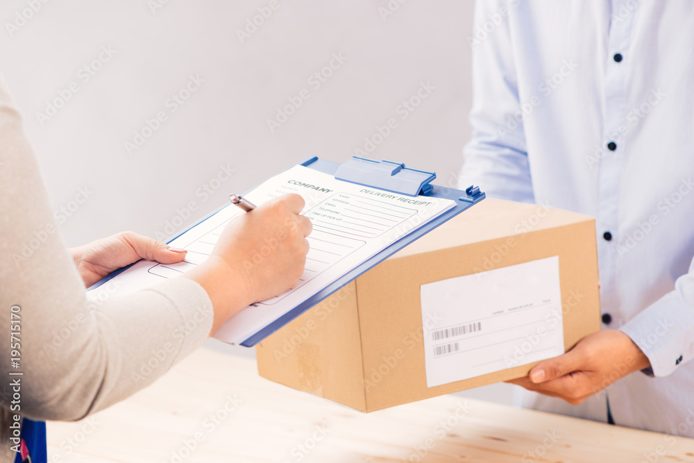 Delivery man presenting receiving form in post office Stock Photo ...