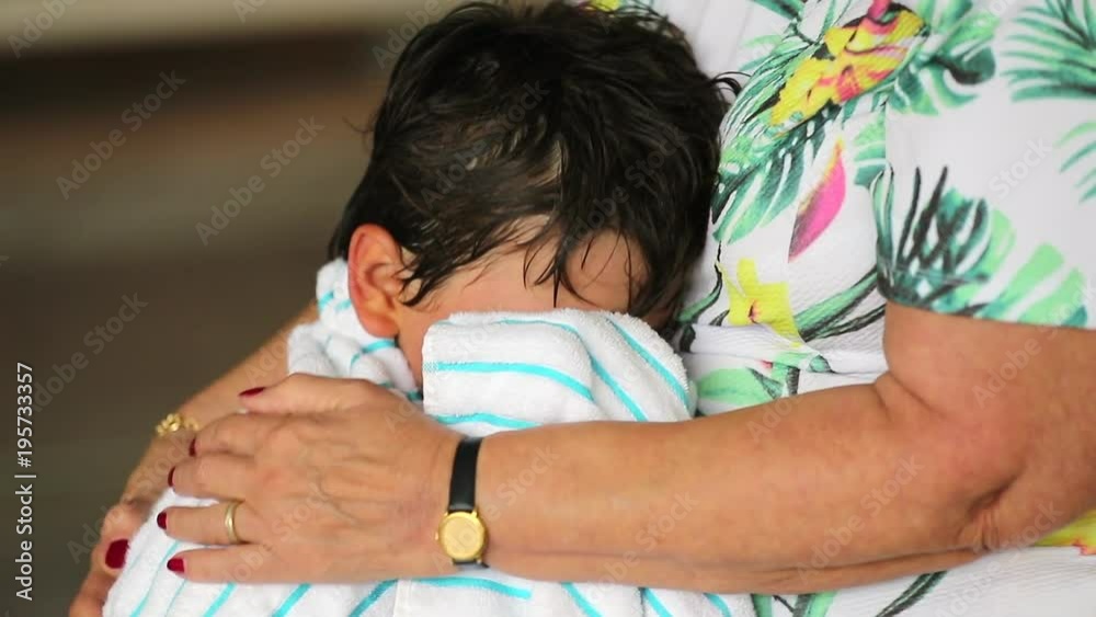 Child crying uncontrollably in grand-mother arms giving him affecting ...