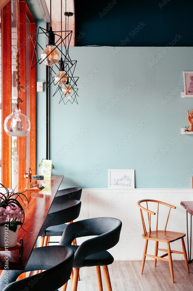 Cafe interior decoration with modern furniture, lamps and pastel wall ...
