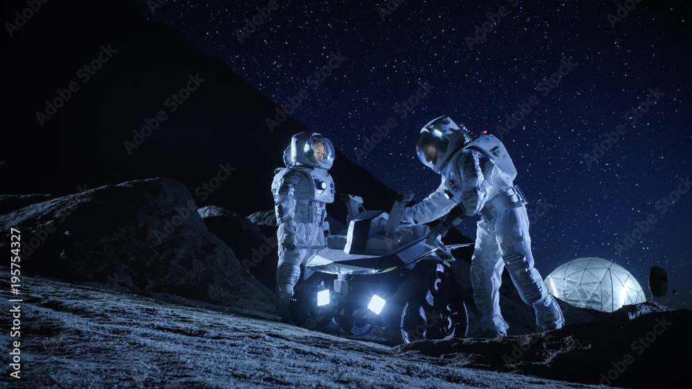 Two Astronauts in Space Suits on an Alien Planet Prepare Space Rover ...