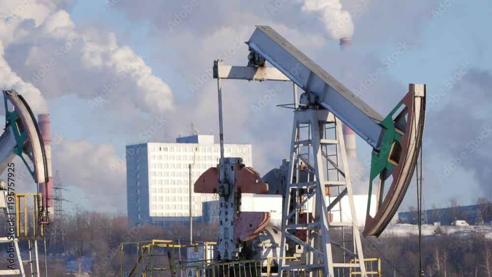 Close-up of a working pump for the extraction of crude oil and of a ...