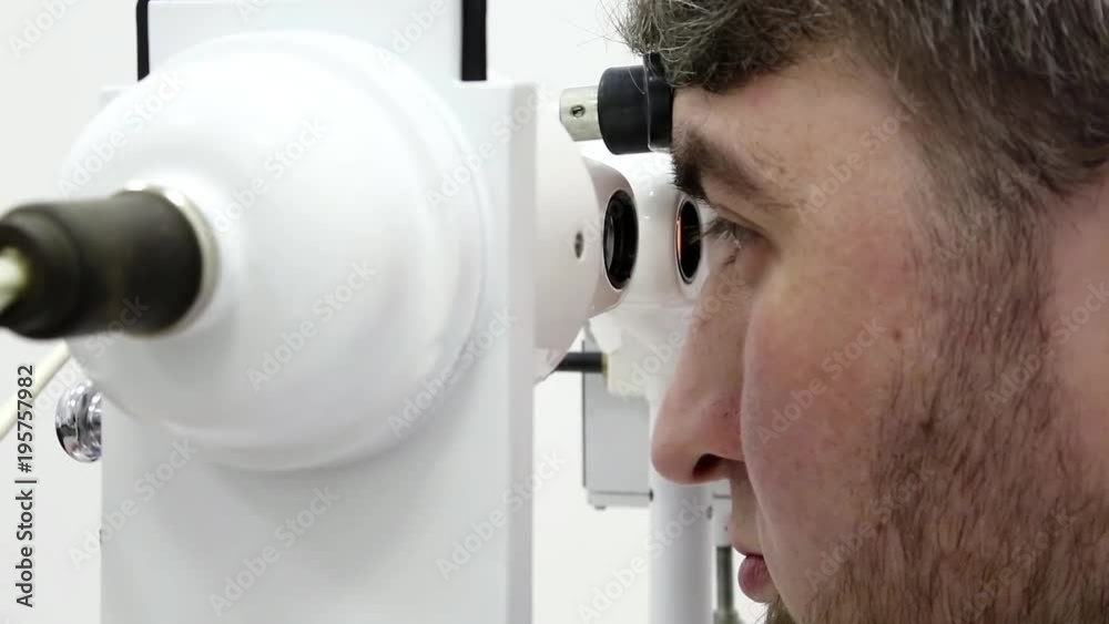 Patient in ophthalmology clinic. Man looks in synoptophore - ophthalmic ...
