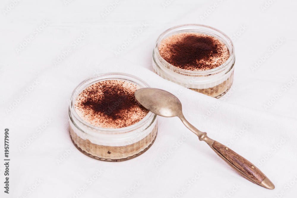 Tiny Italian Tiramisu portions served in a glass cup made of coffee ...