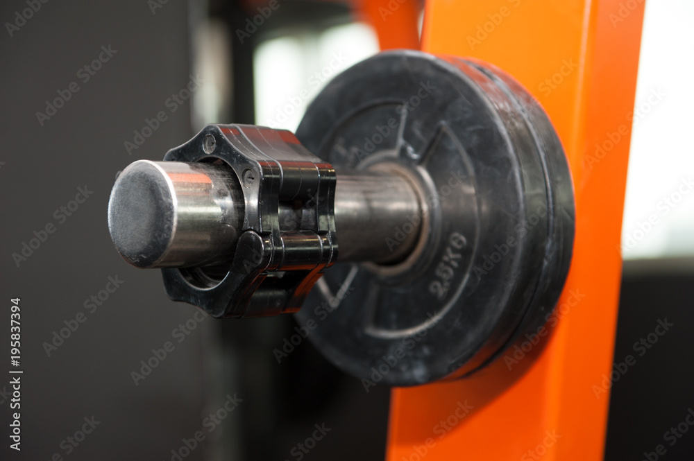 Weights and clamp on a metal bar in a gym Stock Photo | Adobe Stock