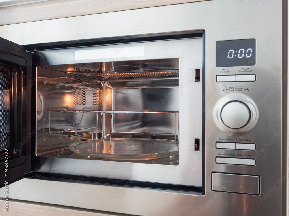 Microwave with timer clock in kitchen Stock Photo | Adobe Stock