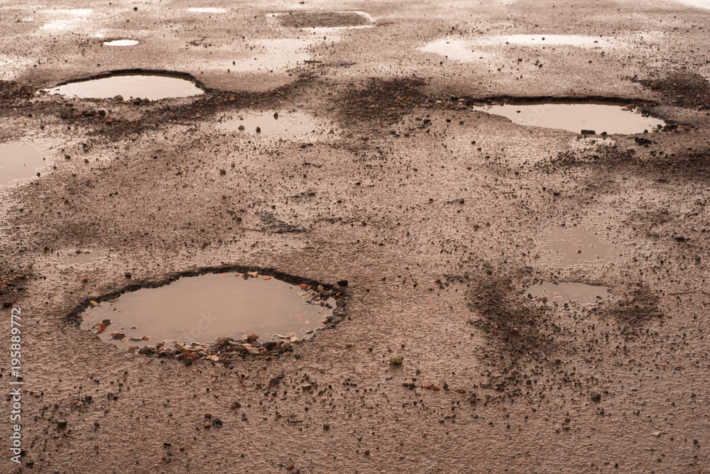 deep and dangerous potholes in UK roads full of water Stock Photo ...