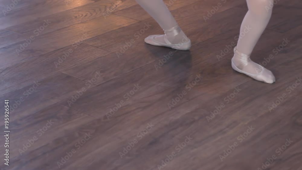 Ballet dancer's feet practices point exercises. Girl tries to perform ...