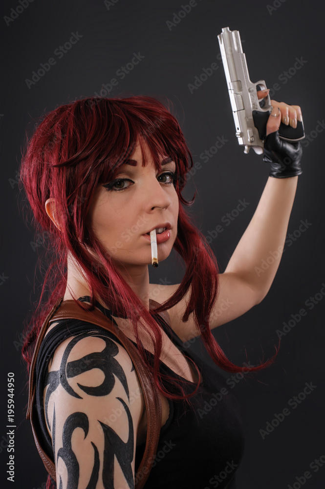 Beautiful redhead woman with gun against dark background Stock Photo ...