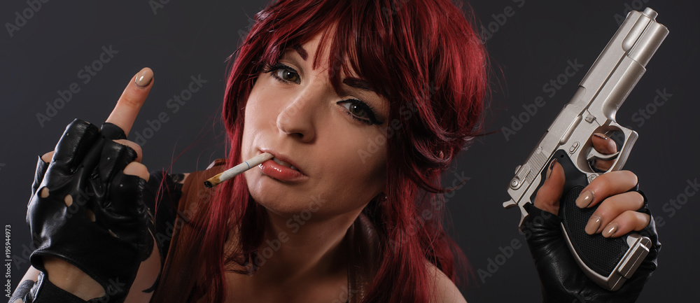 Beautiful redhead woman with gun against dark background Stock Photo ...
