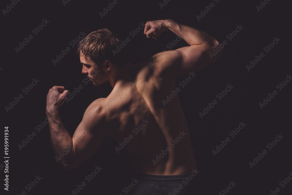 back view image.professional bodybuilder showing his perfect body on ...