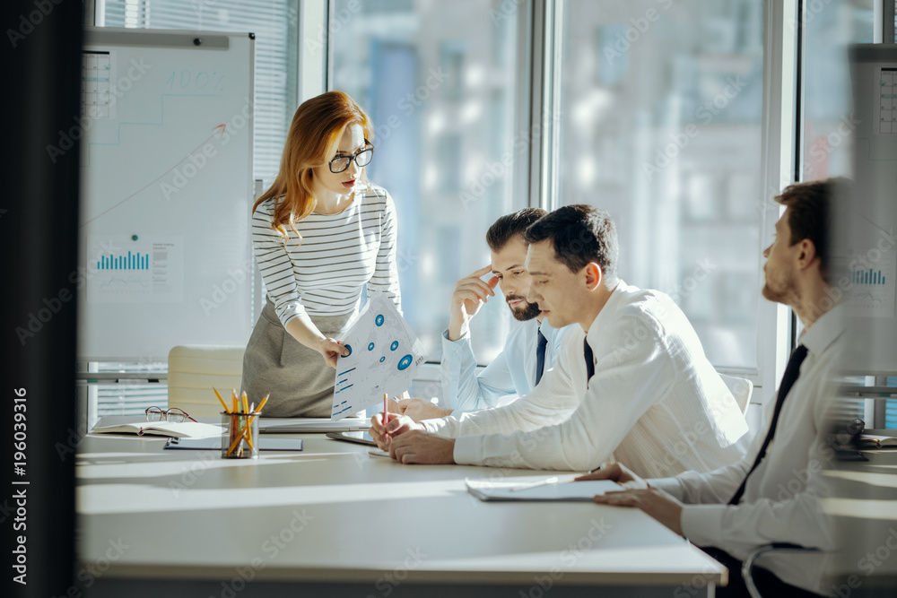 Unacceptable mistakes. Strict female boss reproaching her employees for ...