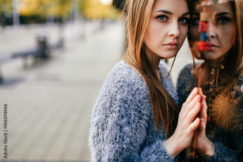 Self reflection portrait of amazing young girl in mirrored window ...