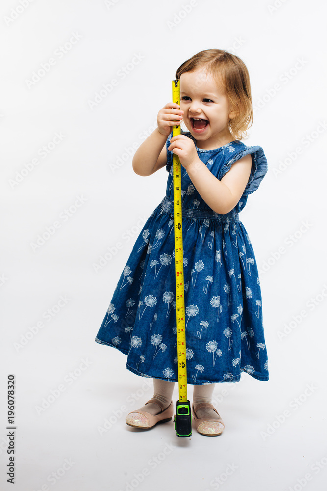 Cute child smiling and holding a measuring tape, they grow fast Stock ...