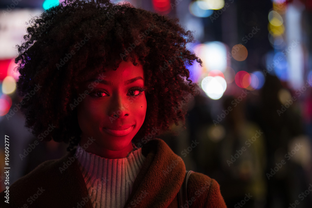 Beautiful African American Woman with red light glow at night in city ...