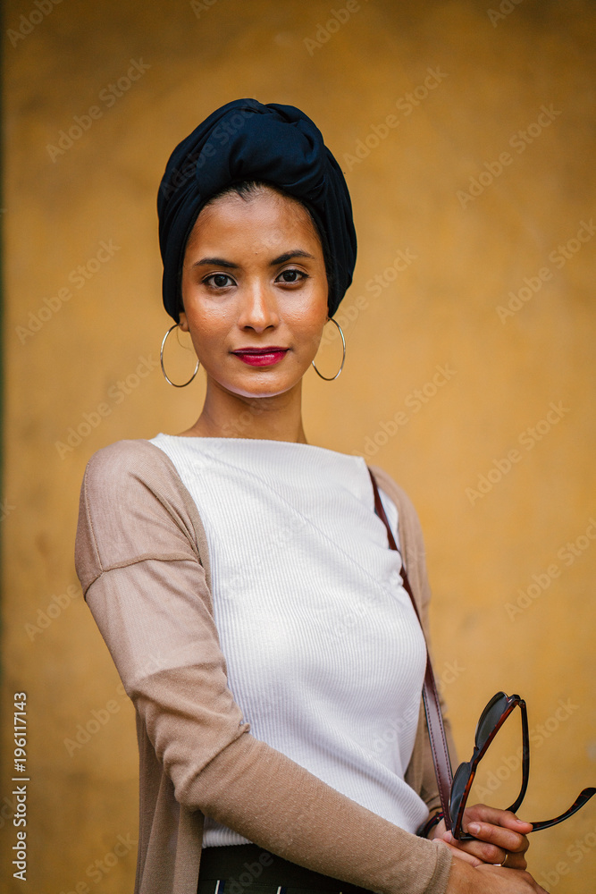 Fashion studio portrait of a young, slim and attractive Muslim Malay ...