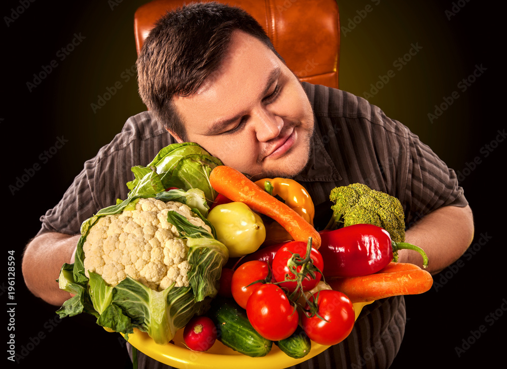 Diet fat man eating healthy food with vegetables cauliflower and sweet ...