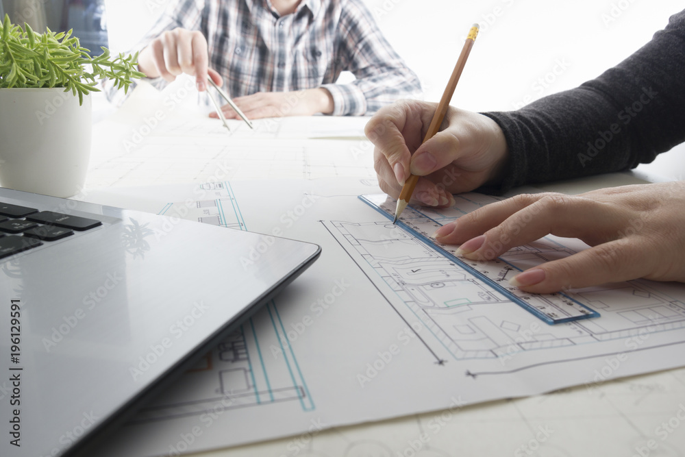 Architects working on blueprint, real estate project. Architect ...