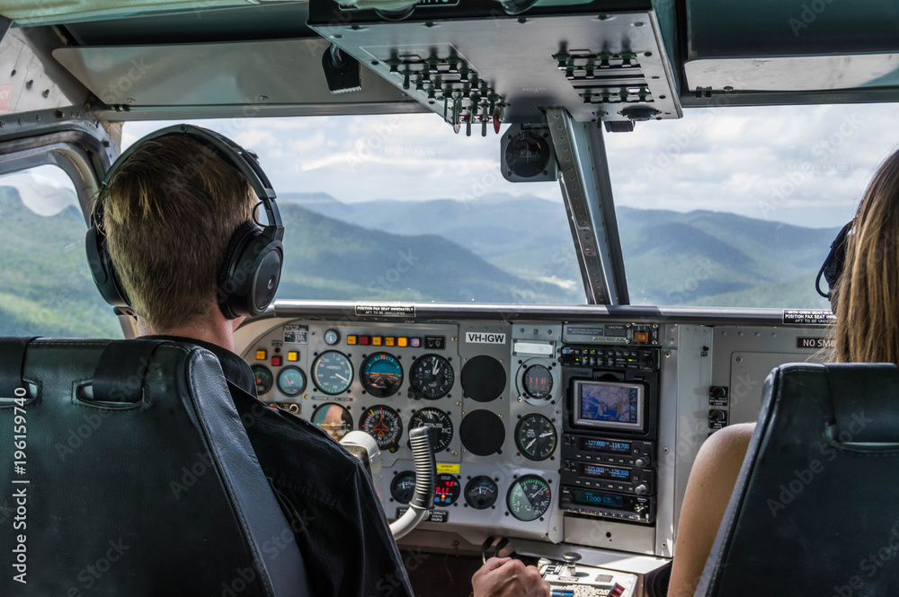 Adult captain of jet airliner wearing black leather jacket and headset ...
