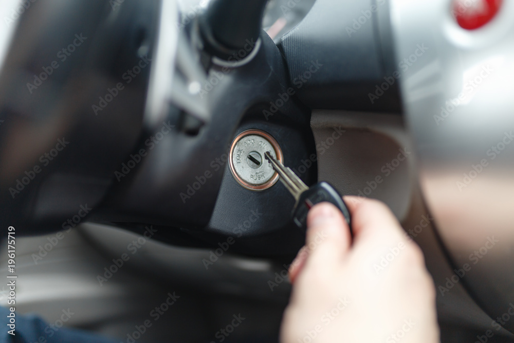 Foto de Hand s man plug in a key starting the engine of a car. The hand ...
