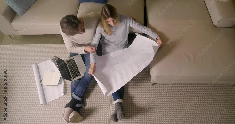 Portrait of a couple in love who is planning new home and furniture ...