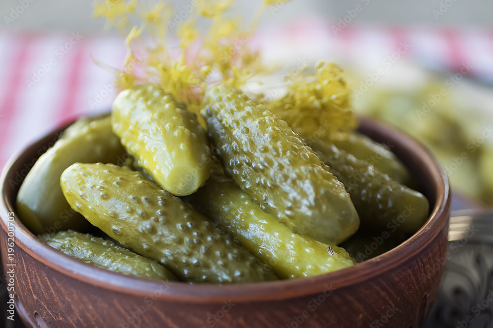 Pickled cucumbers on brown bowl. Pickles, traditional Russian snack ...