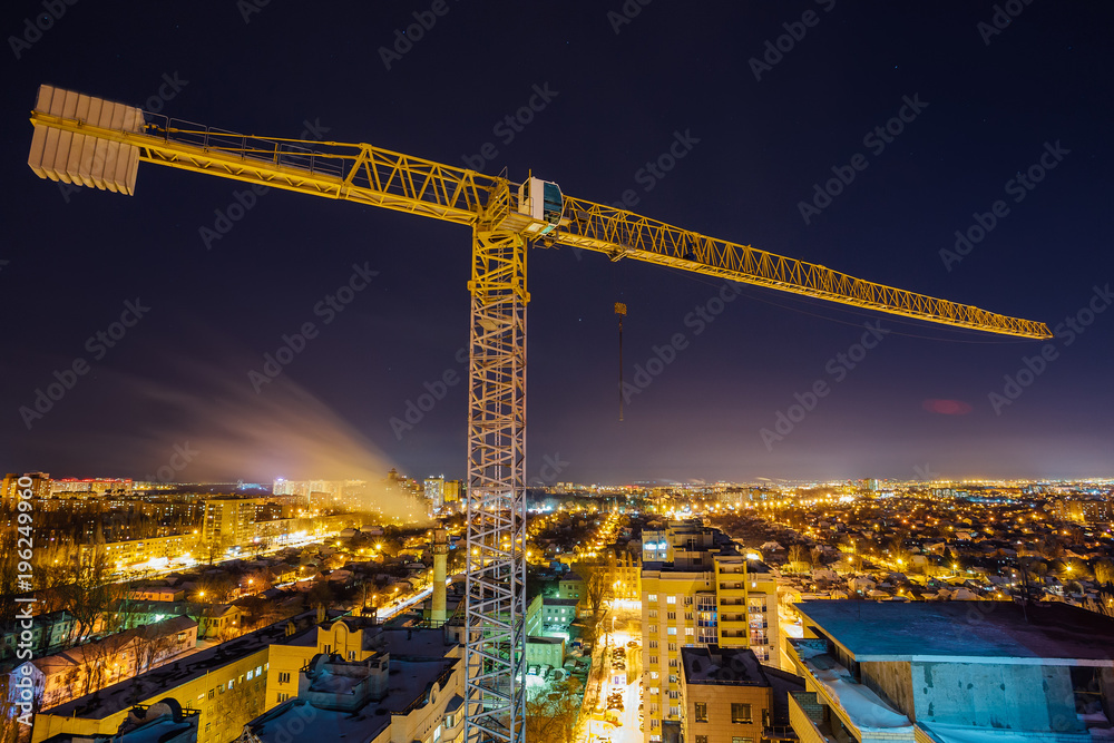 Construction crane at building construction site on night city of ...