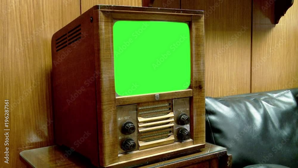 An Old TV Set from the Early 1950s with Green Screen against a Wooden ...