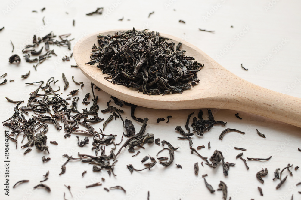 dry black tea in wooden spoon Stock Photo | Adobe Stock