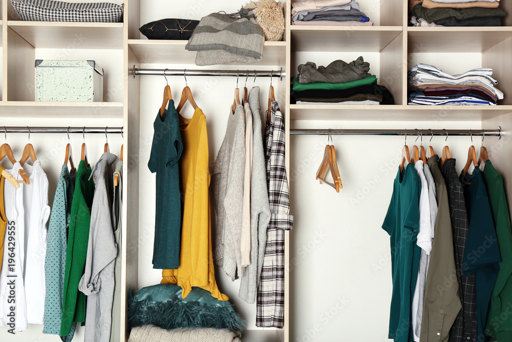 Large wardrobe closet with different clothes and home stuff Stock Photo ...
