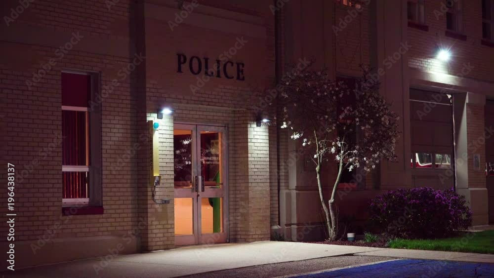 Exterior establishing shot of a small police station at night. Stock ...