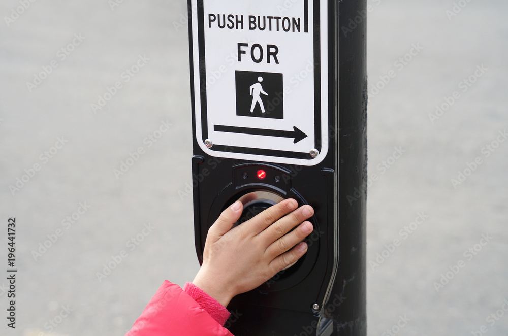 Kids hand push button of pedestrian crossing sign Stock Photo | Adobe Stock