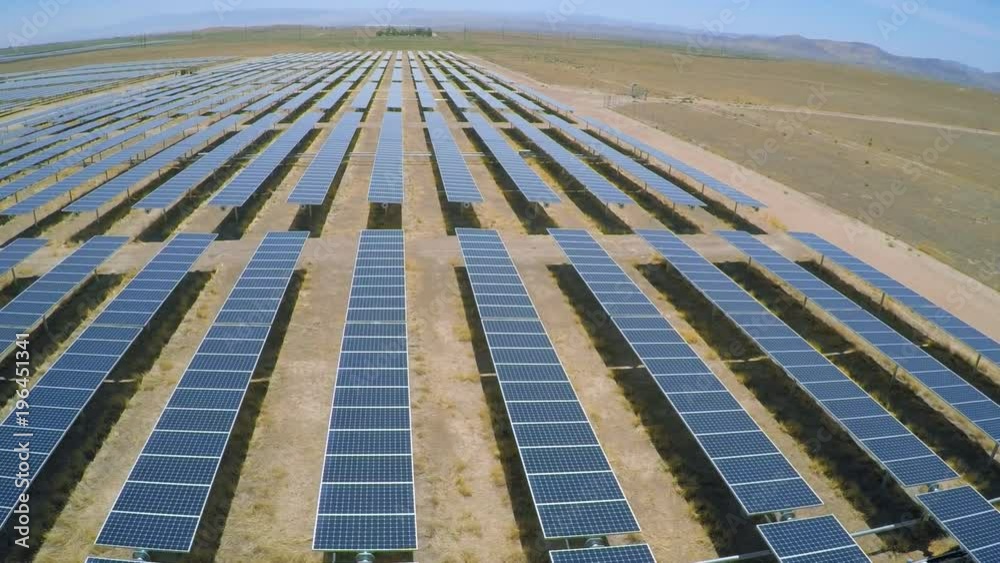 Aerial over a vast solar array farm in the California desert. Stock ...