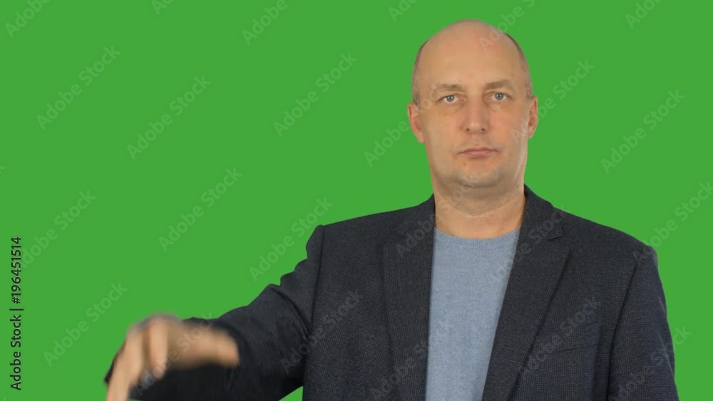 Man showing clenched fist up on right hand on green chroma key ...