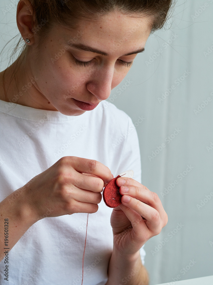 Step-by-step process of manual manufacturing baby crib mobile. Sewing a ...