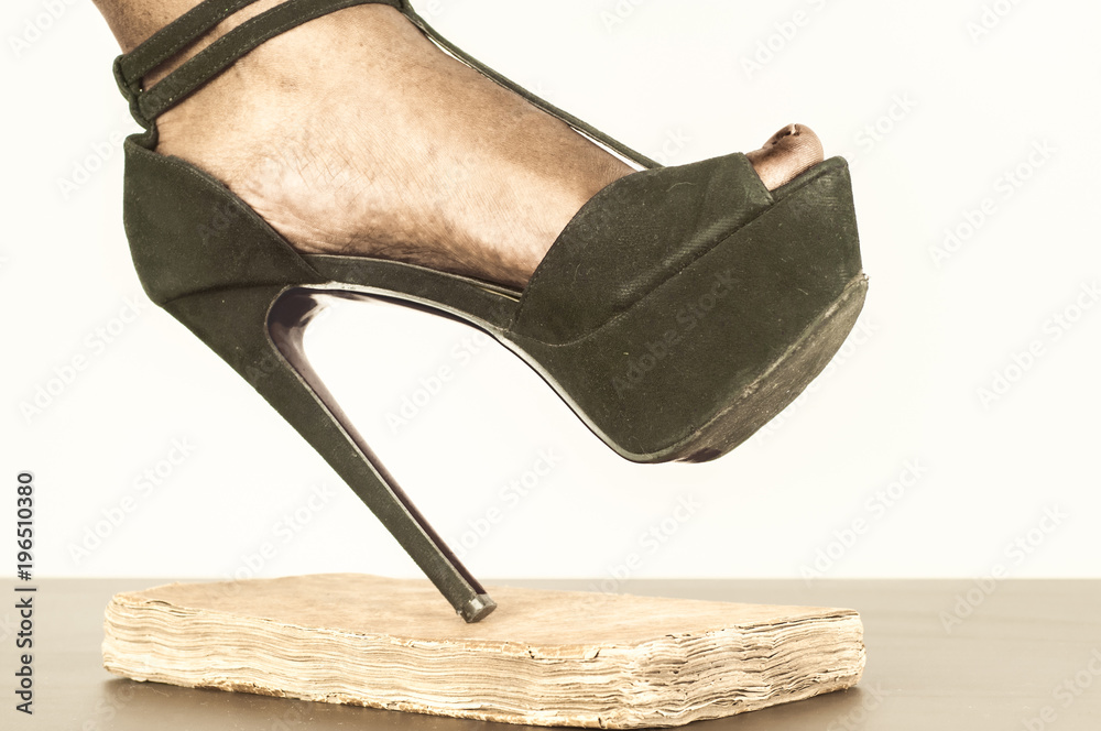 rebel girl step on a symbolic book Stock Photo | Adobe Stock