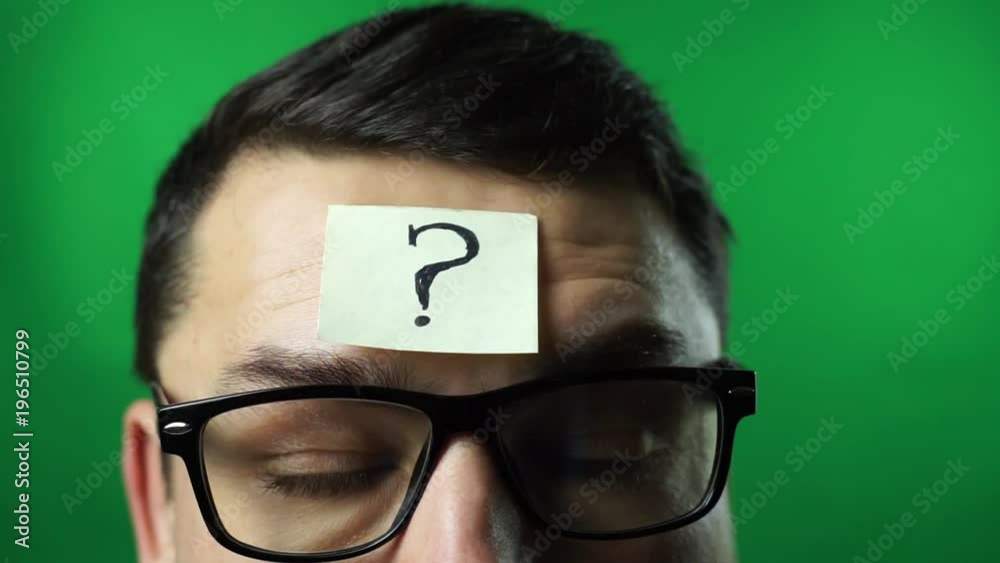 thinking man with question mark on gray wall background green screen ...