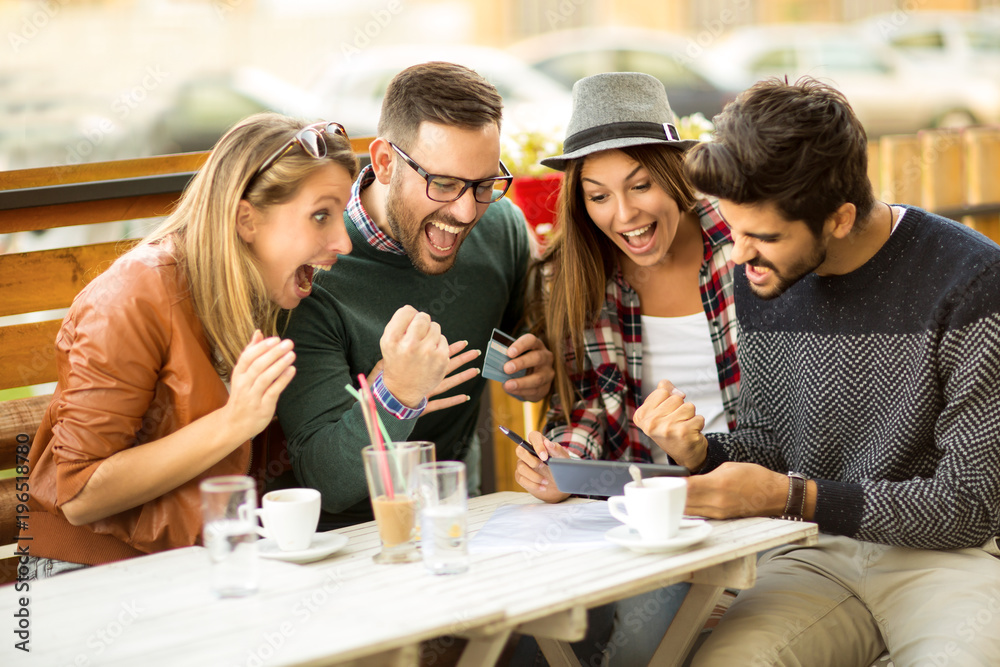 Group of four friends having a coffee together. Two women and two men ...