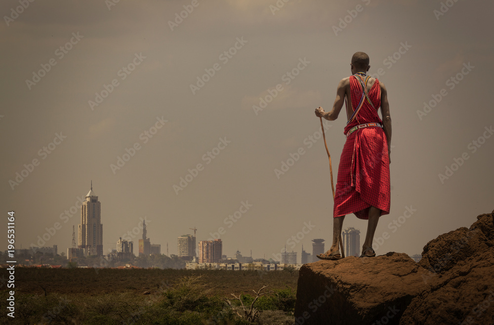Masai man with traditional dress watching Nairobi's skyline, Nairobi ...