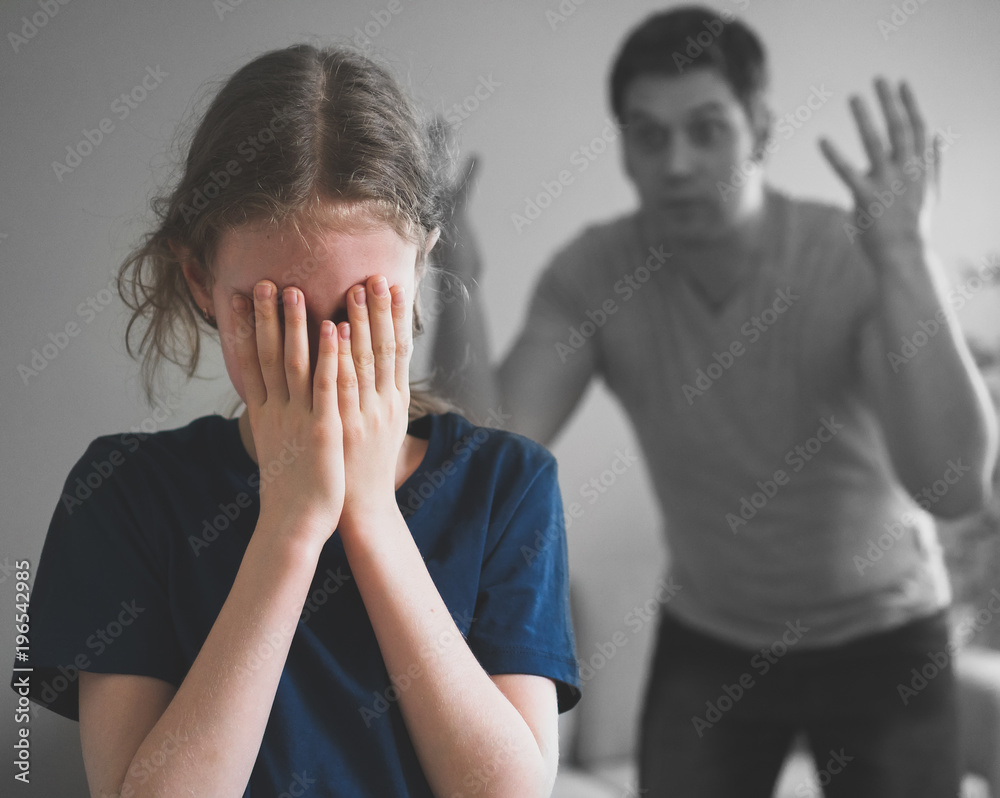 Angry father yelling at his daughter at home. Stock Photo | Adobe Stock