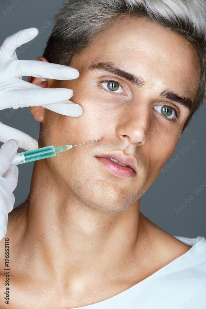 Doctor giving botox injection on face of young man. Photo of Man ...