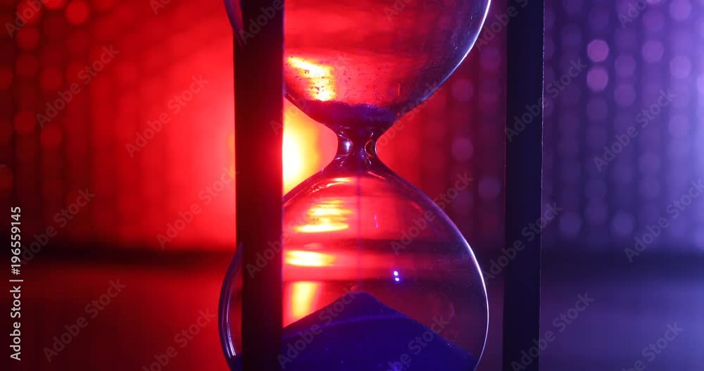 Time concept. Silhouette of Hourglass clock on dark toned backlight ...