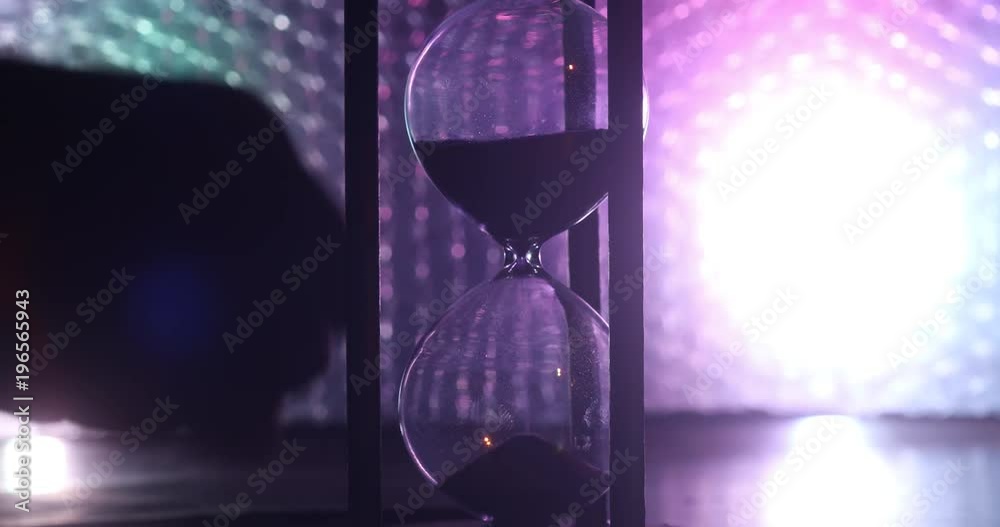 Vidéo Stock Time concept. Silhouette of Hourglass clock on dark toned ...