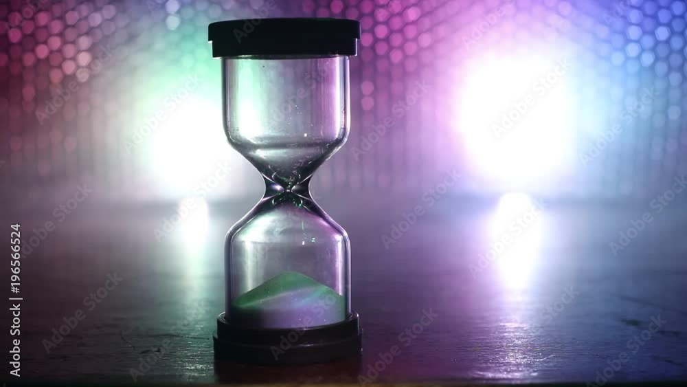 Time concept. Silhouette of Hourglass clock on dark toned backlight ...