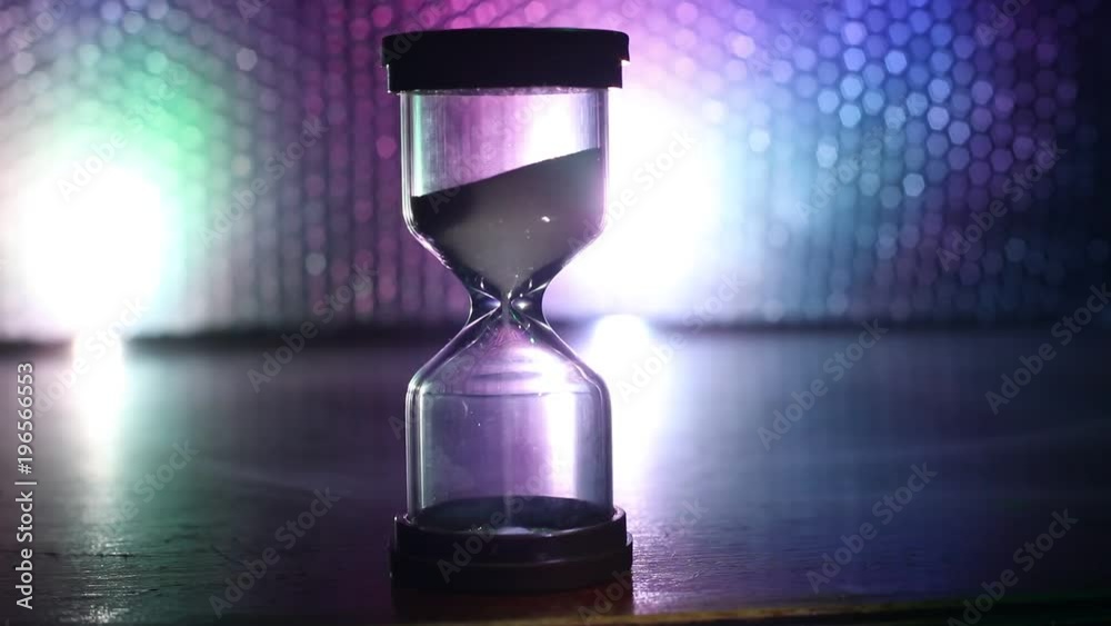 Time concept. Silhouette of Hourglass clock on dark toned backlight ...